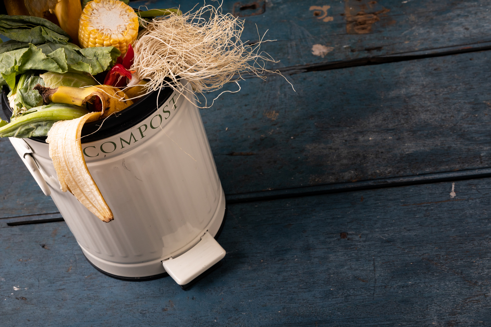 High angle view of organic rubbish in compost bin on wooden table ...